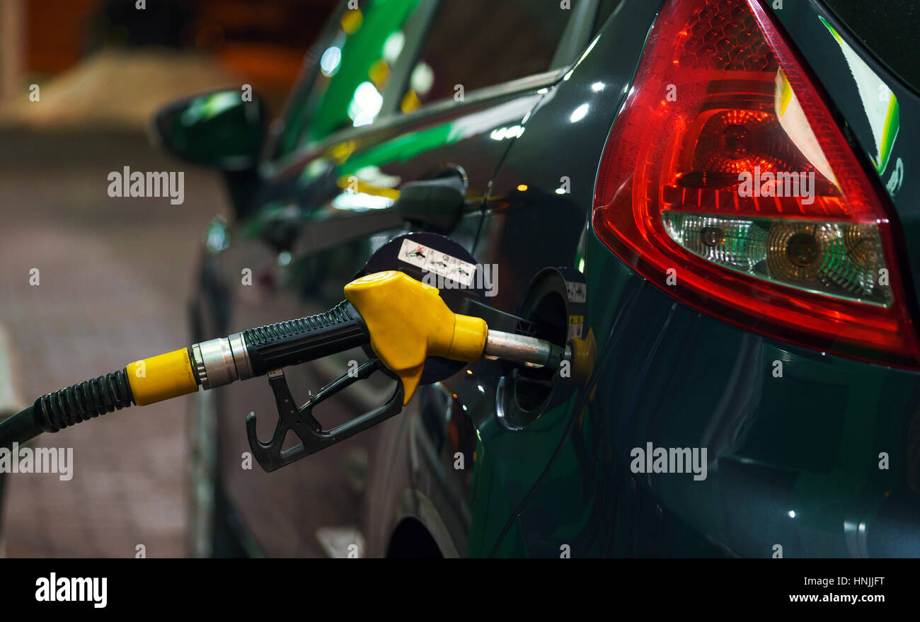 Car refueling on a petrol station in winter at night closeup Stock ...