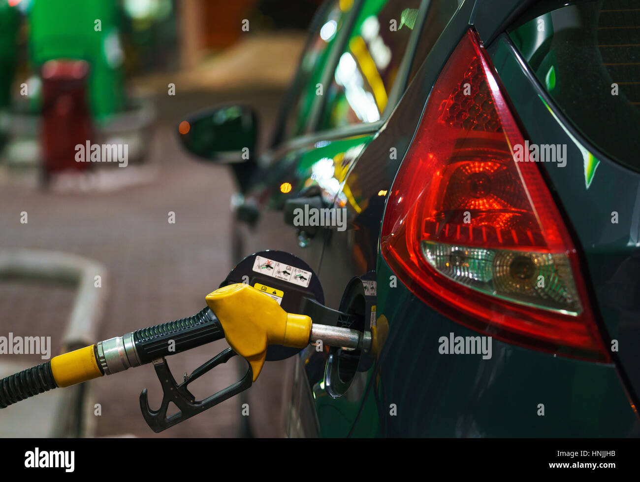 Car refueling on a petrol station in winter at night closeup Stock ...