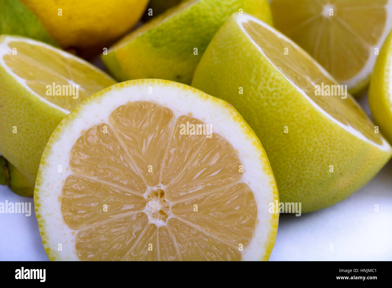 Cut lemons and isolated with white background Stock Photo - Alamy