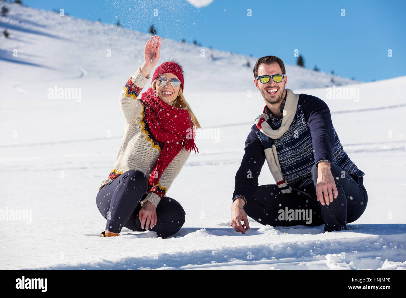 Couple enjoying snowball fight in hi-res stock photography and images ...