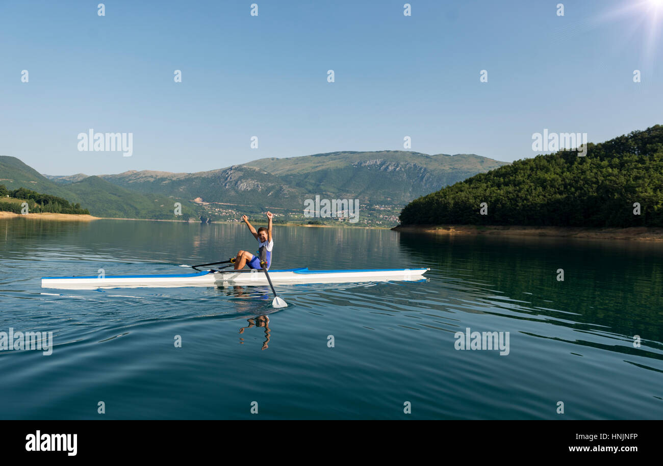 The young sportsman is rowing on the racing kayak Stock Photo - Alamy