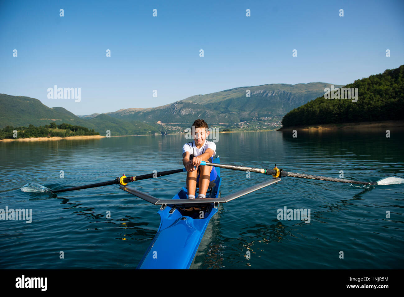 The young sportsman is rowing on the racing kayak Stock Photo - Alamy