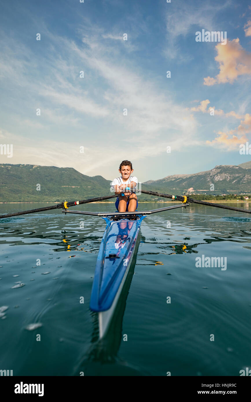 The young sportsman is rowing on the racing kayak Stock Photo - Alamy