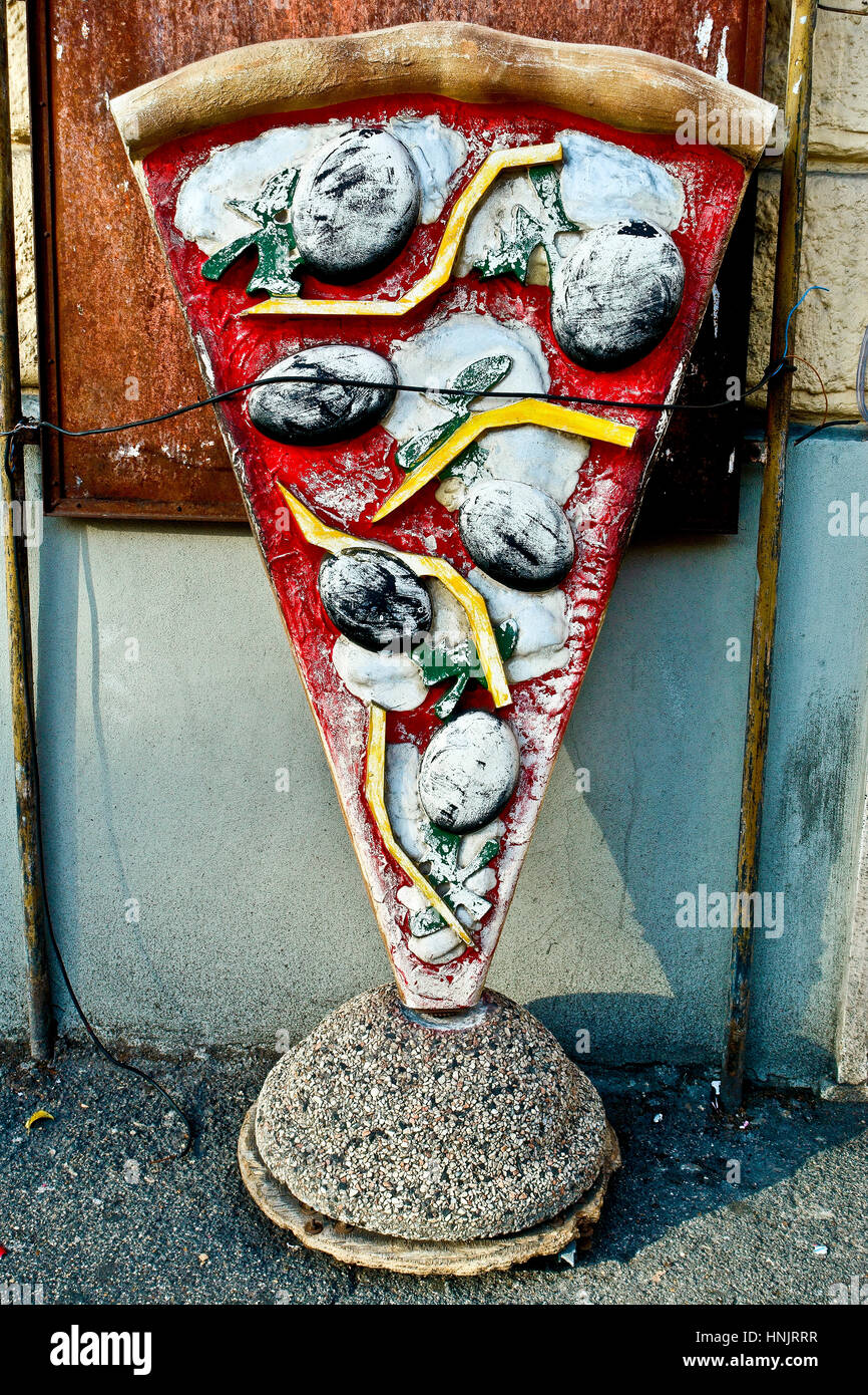 Advertising pizza giant slice sign standing outside an italian ...