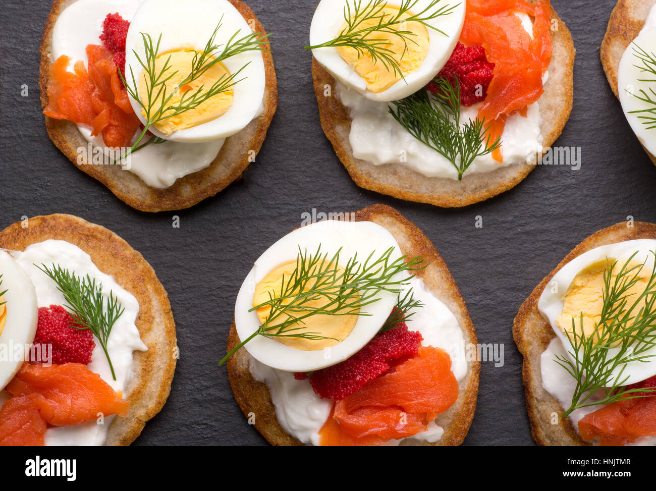 Traditional russian blini with sour cream and red caviar. Top view ...