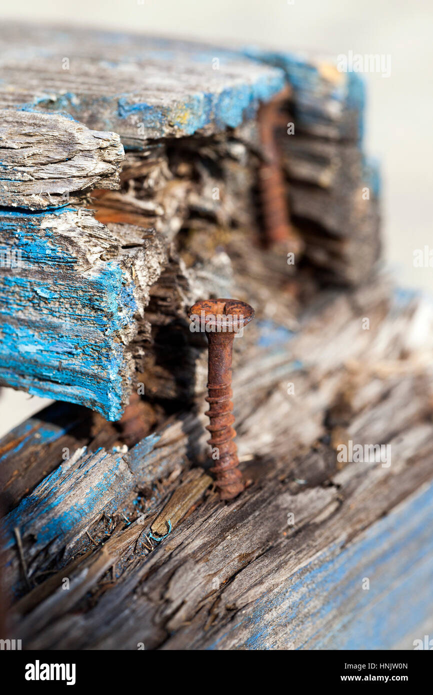 photographed close up old rusty screw that secures the board broken ...