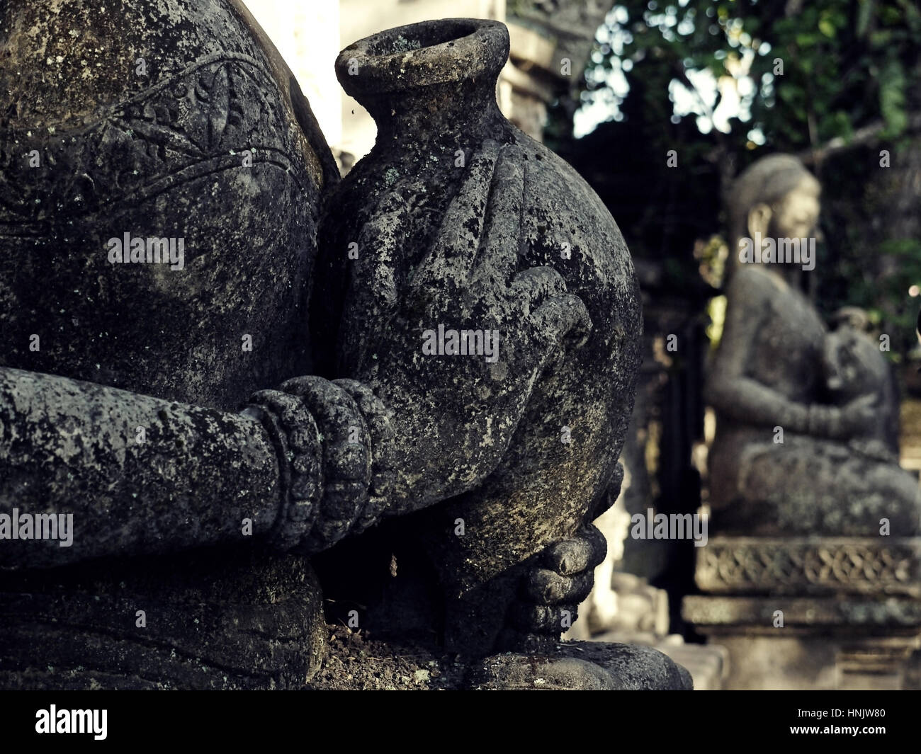 Woman with a pitcher stone sculpture. Bali, Indonesia Stock Photo - Alamy