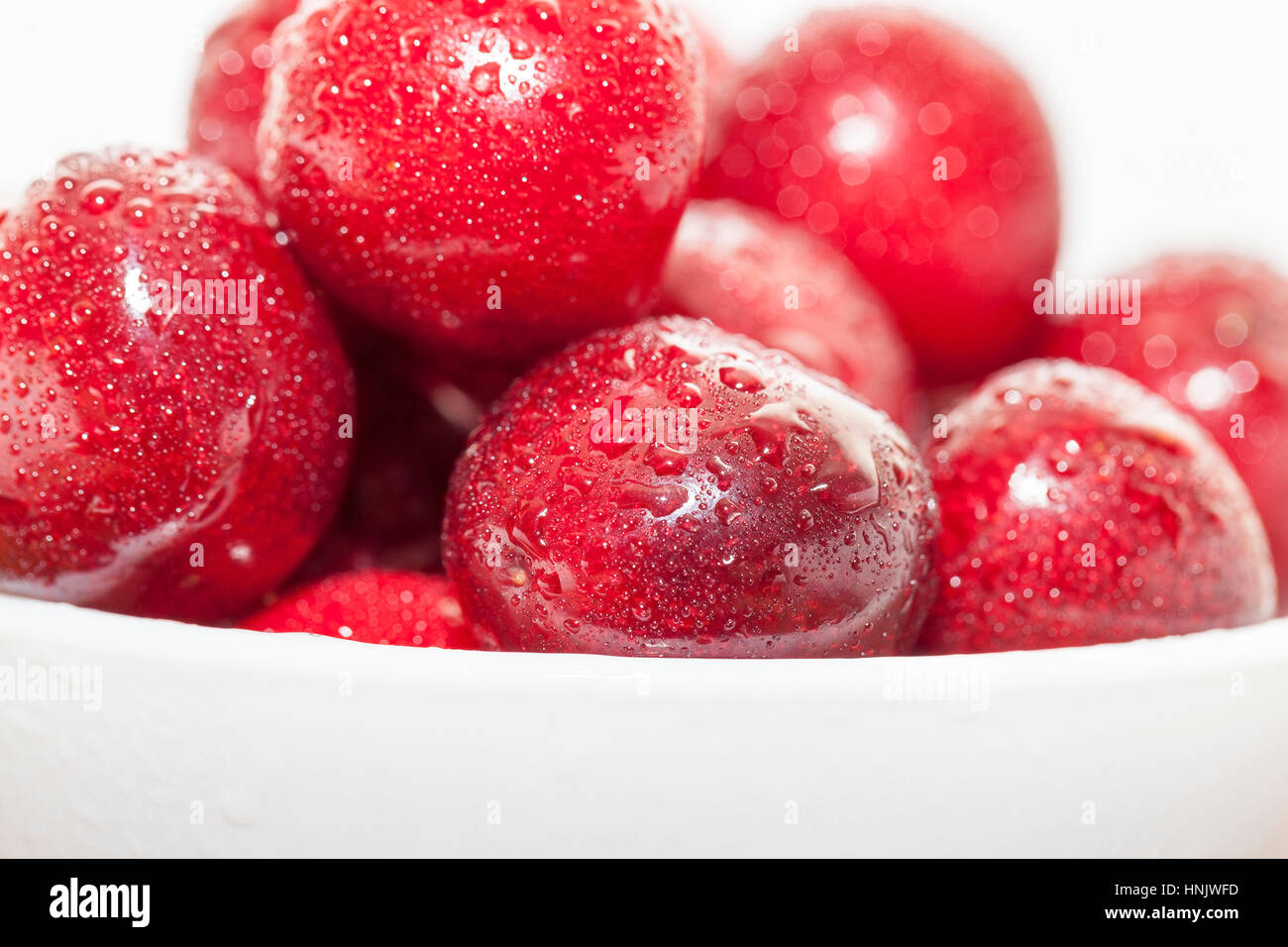 ripe cherry maroon covered with water drops. Berries are together after ...