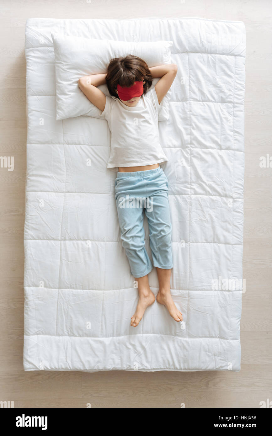 Relaxed funny guy lying in a mask Stock Photo - Alamy