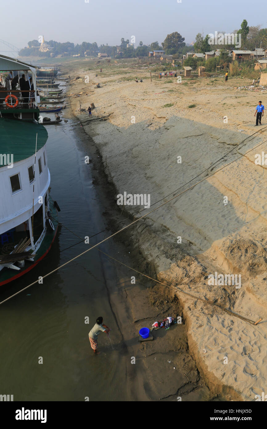 A woman is washing clothes in the Irrawaddy River at Sagaing, Myanmar ...