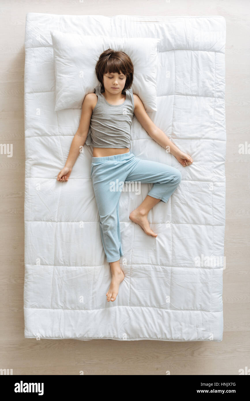 Sleepy child finding the right pose Stock Photo - Alamy