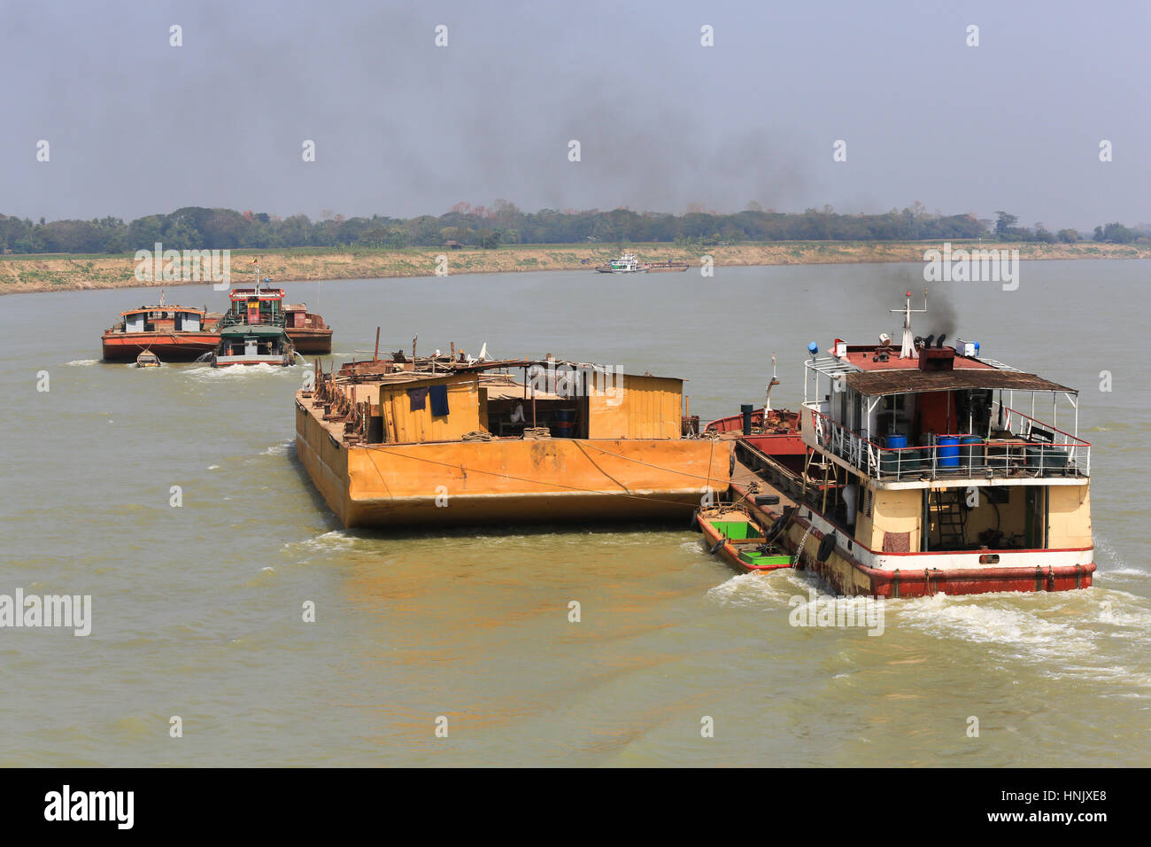 Three tugs pushing barges on the Irrawaddy River in Myanmar (Burma ...