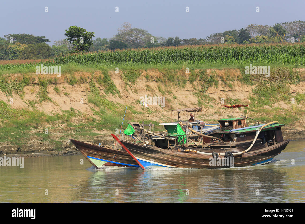 Two wooden river dredge boats lashed together and underway on the ...