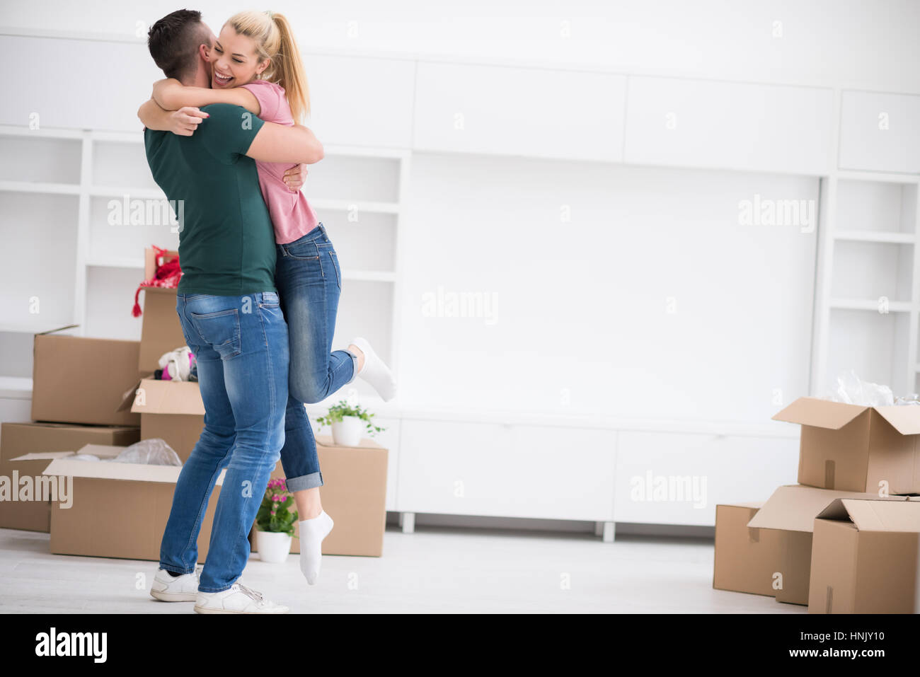 excited happy young couple looking forward to moving into a new home ...