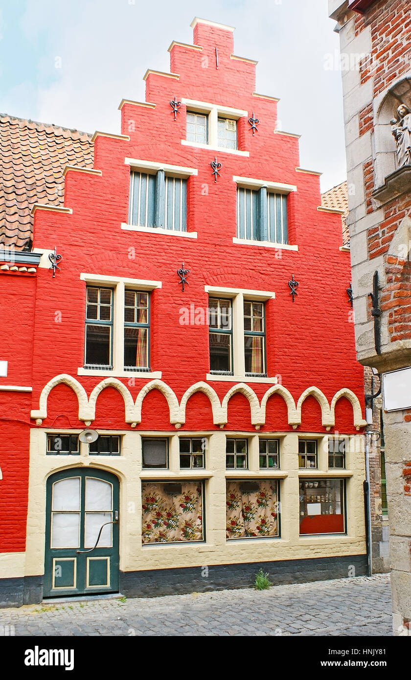 The bright red facade of the Flemish Revival Style house with the ...
