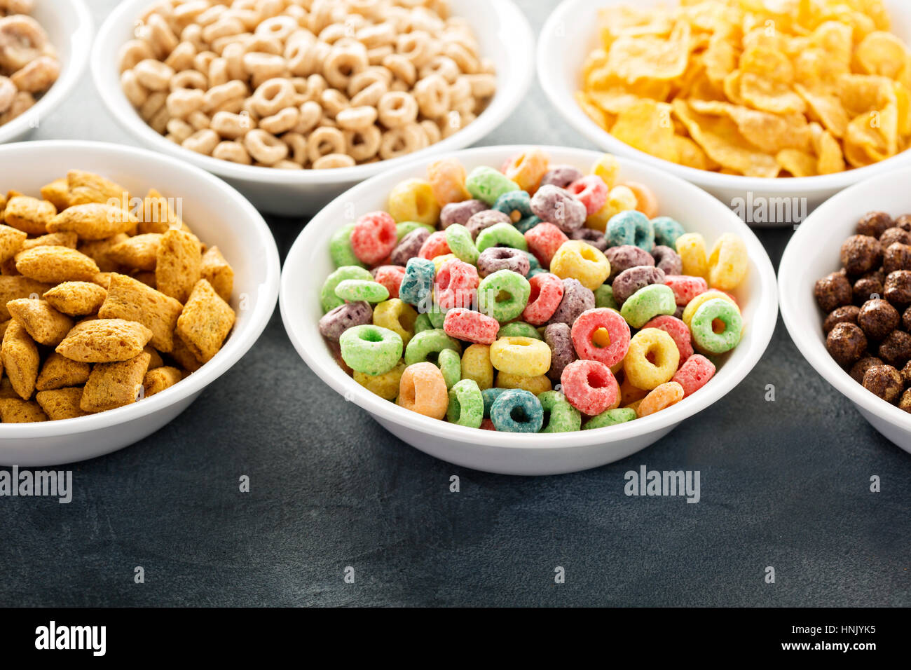 Variety of cold cereals in white bowls, quick breakfast for kids Stock ...