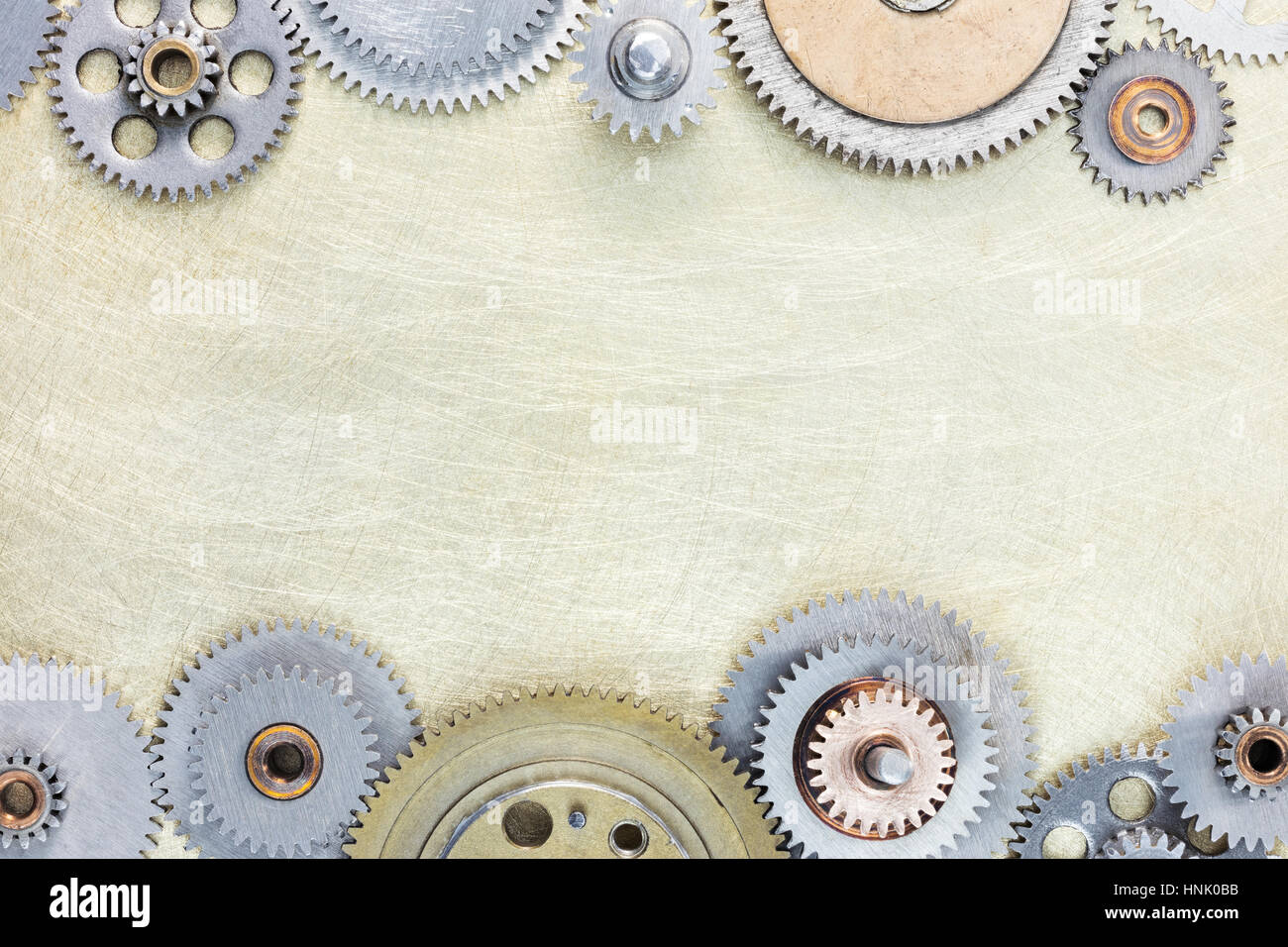 set of various mechanical gears on brushed metal industrial background ...