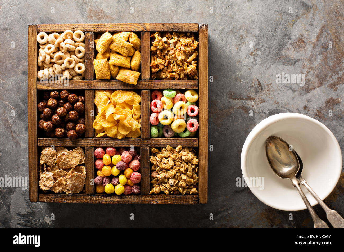 Variety of cold cereals in a wooden box, quick breakfast for kids ...