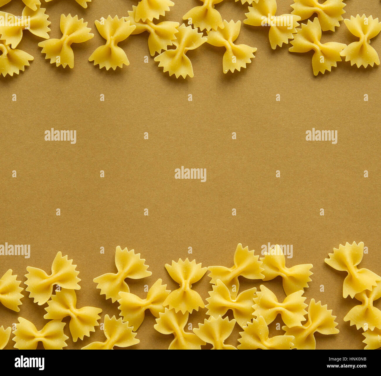 Pasta bow and spiral shape on brown background Stock Photo - Alamy