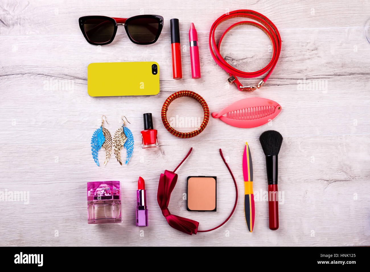 Phone, sunglasses and cosmetics Stock Photo - Alamy