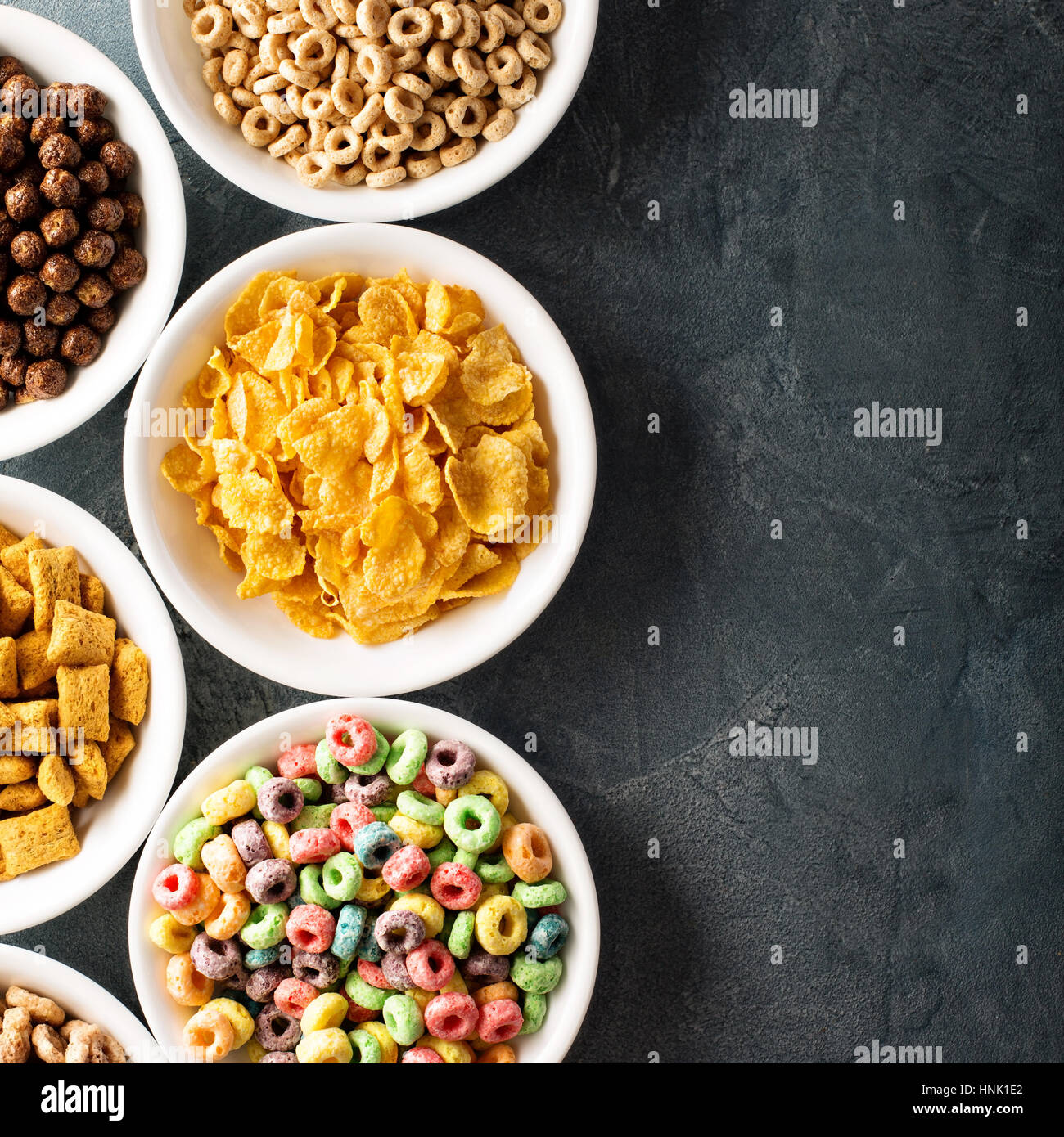 Variety of cold cereals in white bowls, quick breakfast for kids ...