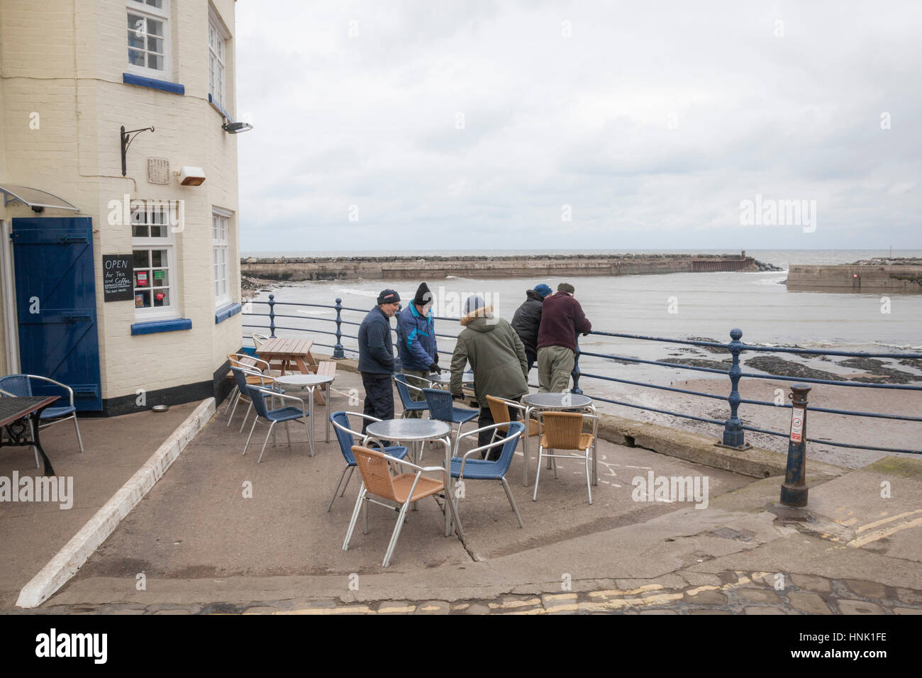 Tourists prepare to sit down for refreshments outside the Cod and ...