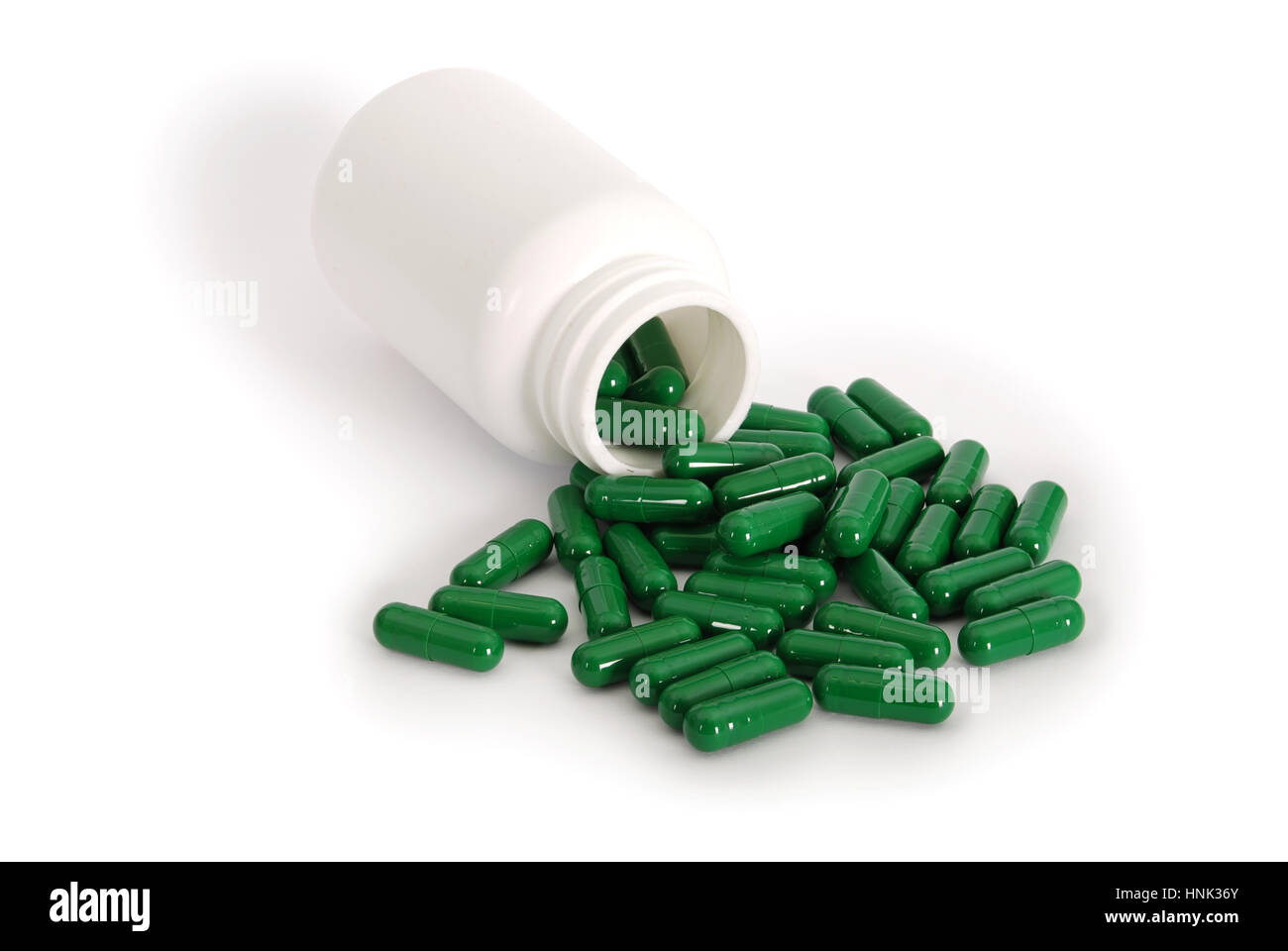 Group green capsules isolated on white background Stock Photo - Alamy