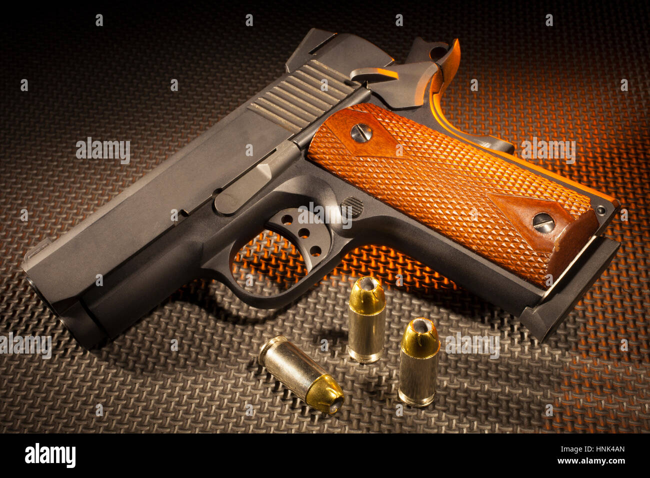 Semi automatic handgun with three bullets on a rubber mat Stock Photo ...
