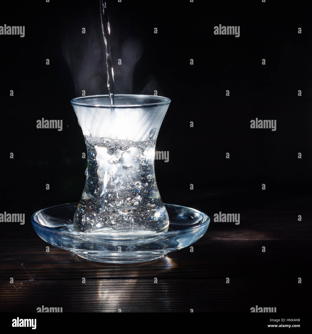 Transparent glass cup with swell the boiling water into it. The vapor ...