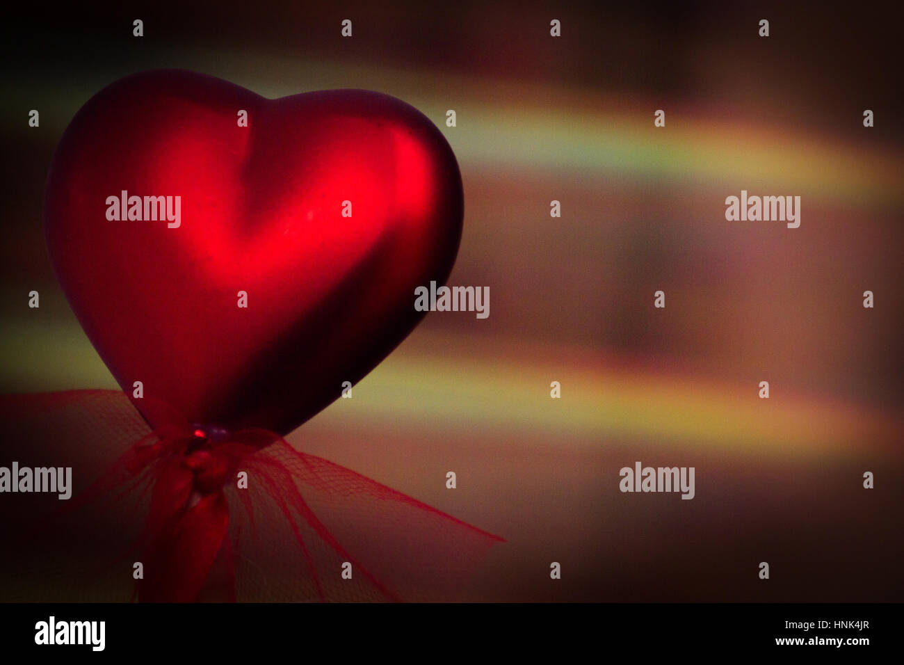 Opaque red heart on lighter background Stock Photo - Alamy