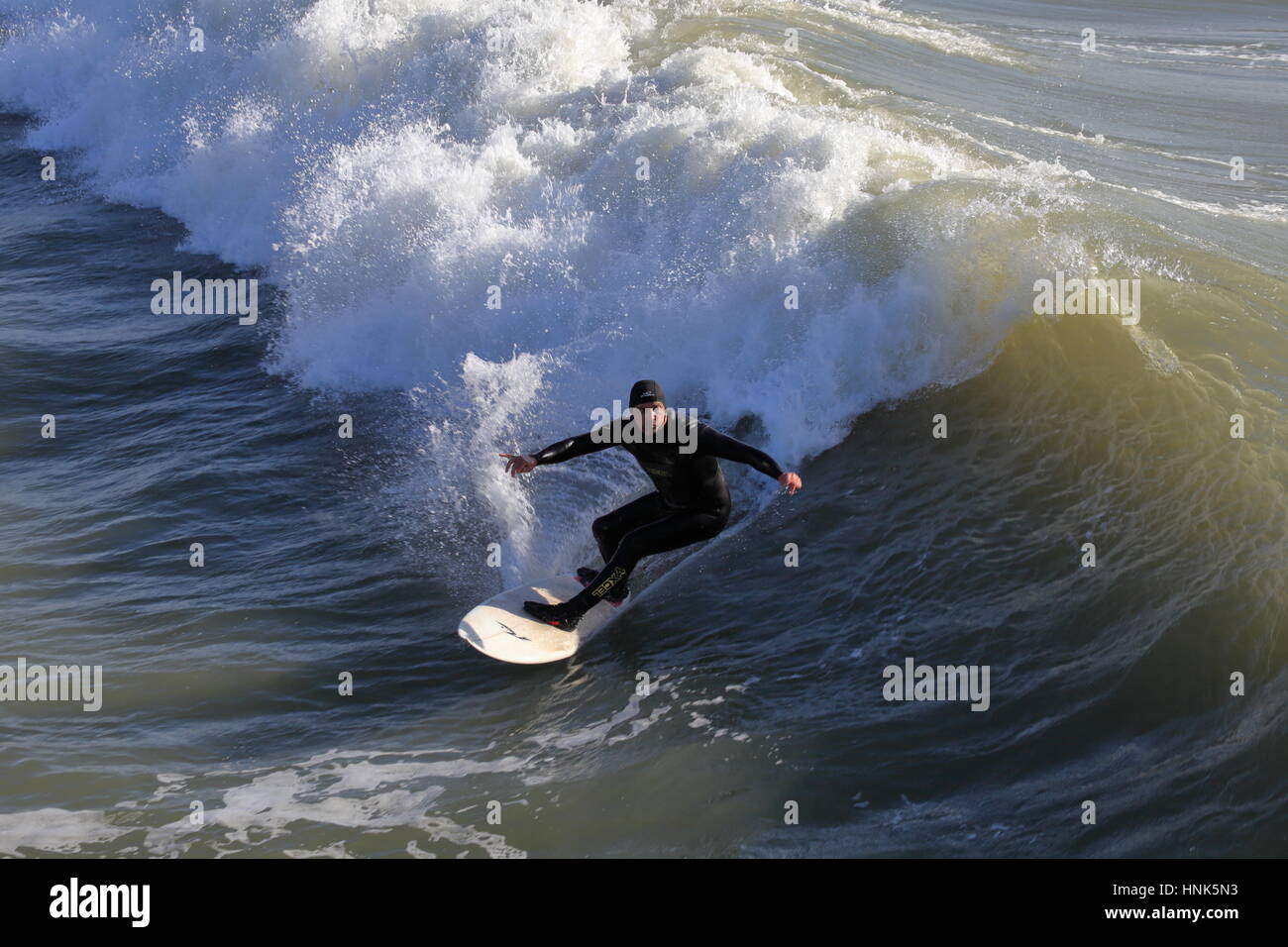Surf boarder concentration as he perfectly catches the huge swell off ...