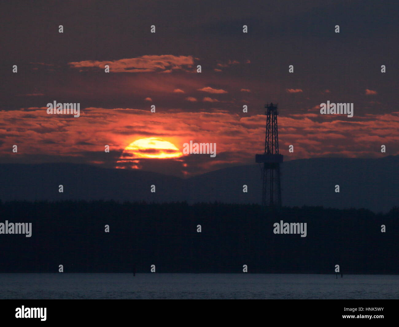 Wytch Farm oil rig in dramatic sunset over Poole Harbour, Dorset UK ...
