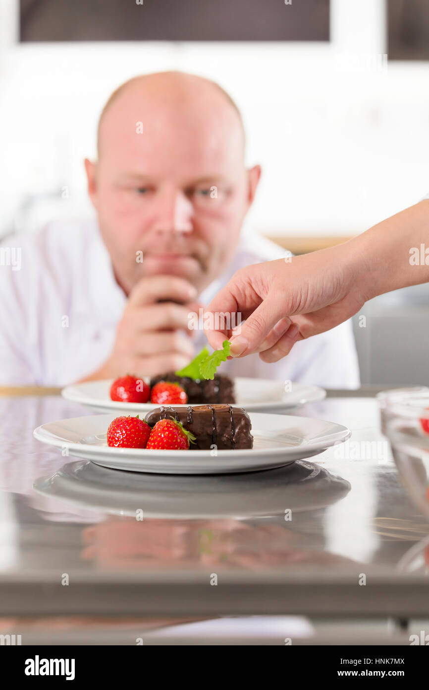 Chef decorate dessert cake with strawberry Stock Photo - Alamy