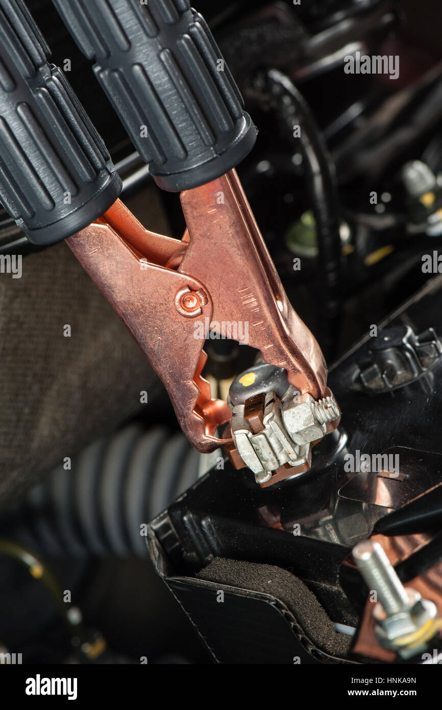 car battery with jumper cable in engine room Stock Photo - Alamy