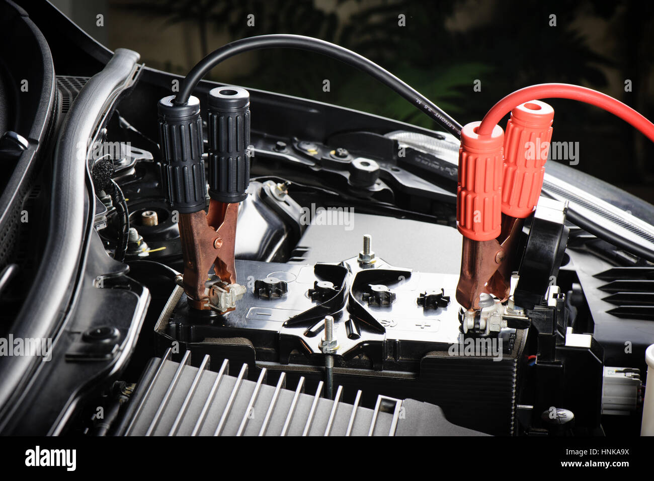 car battery with jumper cable in engine room Stock Photo - Alamy