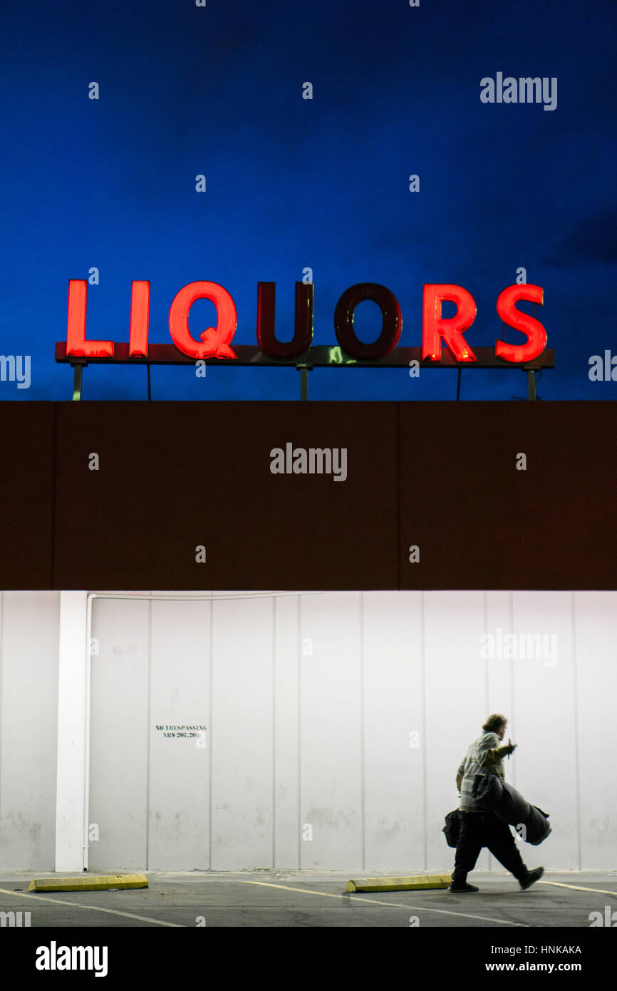 A man walks past a liquor store in downtown Las Vegas Stock Photo - Alamy