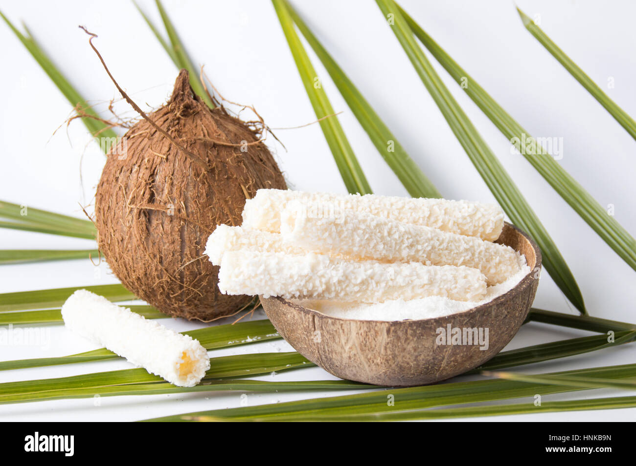 Coconut roller dessert in a shell on white Stock Photo - Alamy