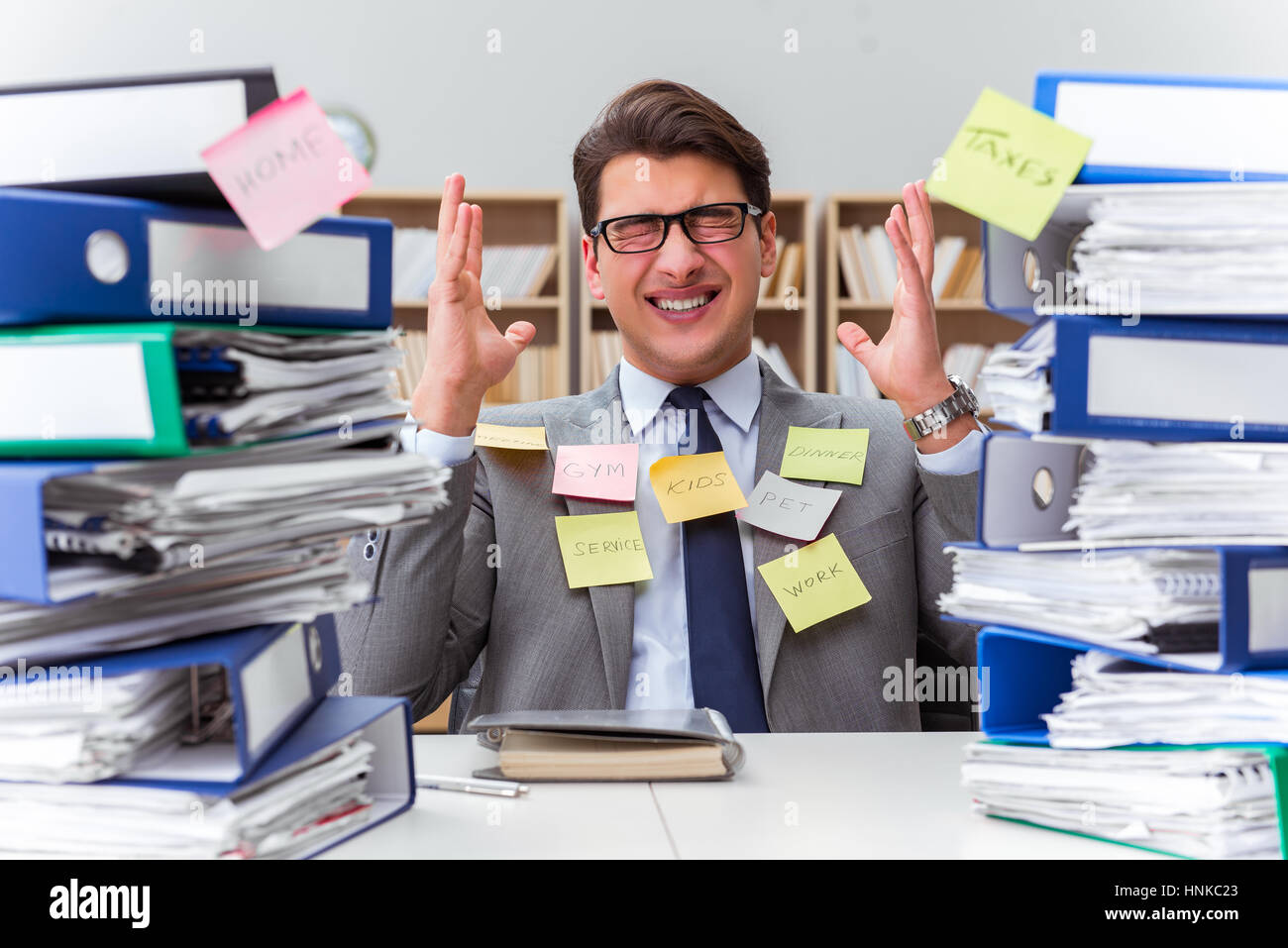 Businessman struggling with multiple priorities Stock Photo - Alamy