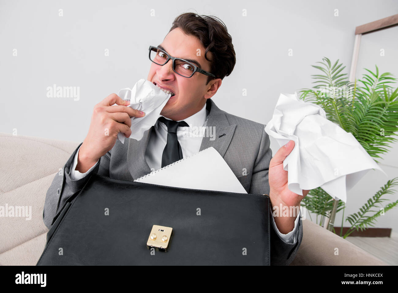 Angry businessman with crumbled paper Stock Photo - Alamy