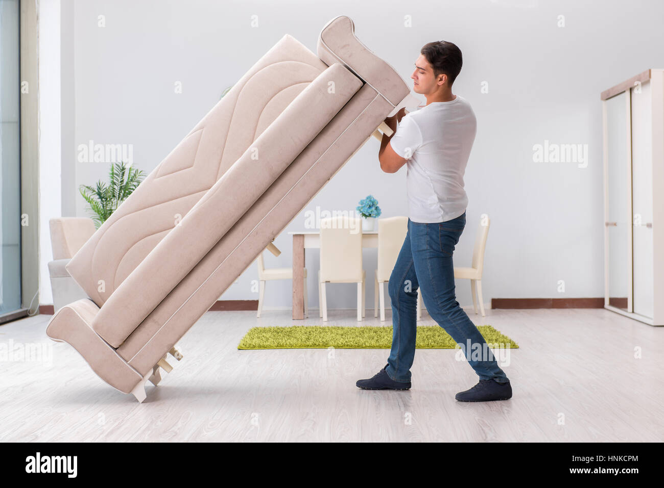 Man moving furniture at home Stock Photo - Alamy