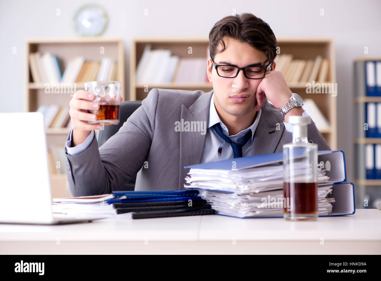 Young businessman drinking from stress Stock Photo - Alamy