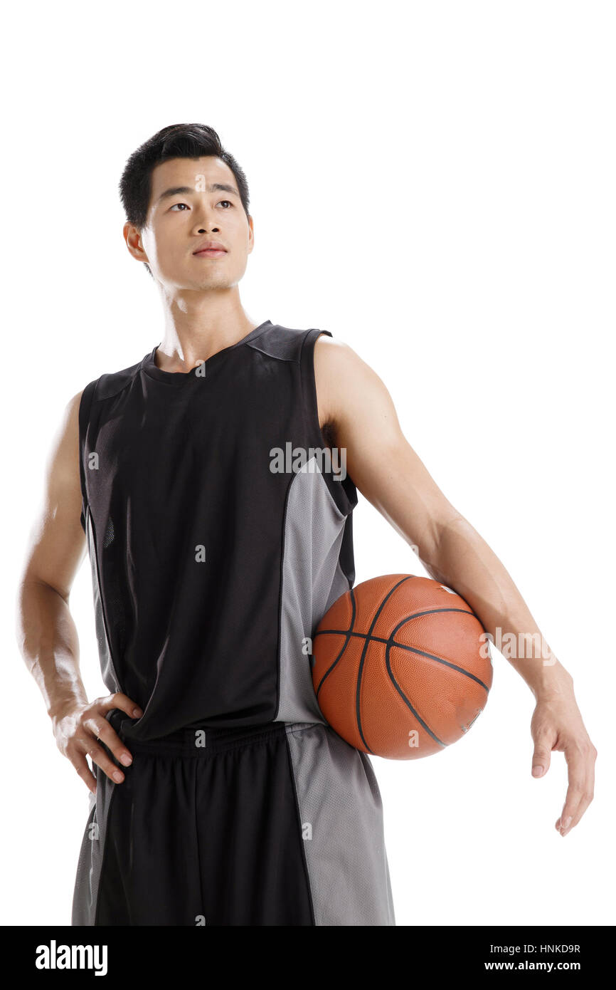 Hip young man holding basketball hi-res stock photography and images ...