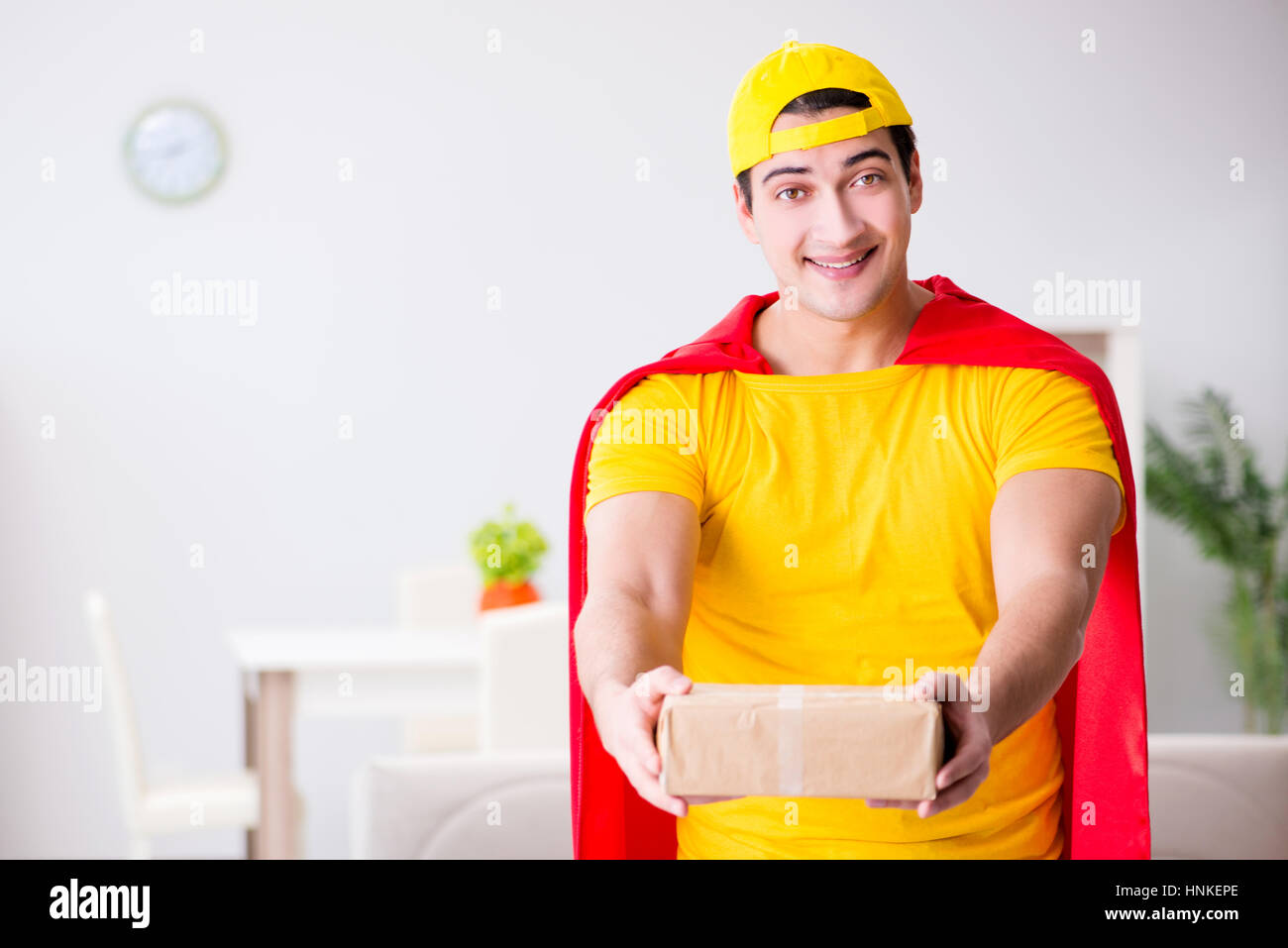 Superhero delivery guy with box Stock Photo - Alamy