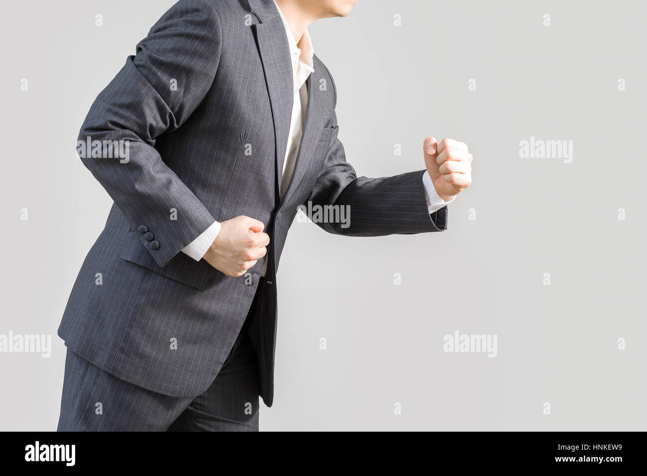 Studio shot of businessman in rush running forward, isolated on white ...