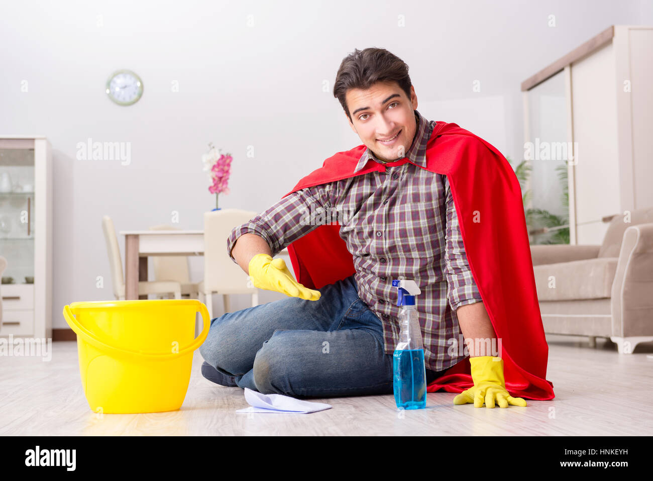 Super hero husband cleaning floor at home Stock Photo - Alamy
