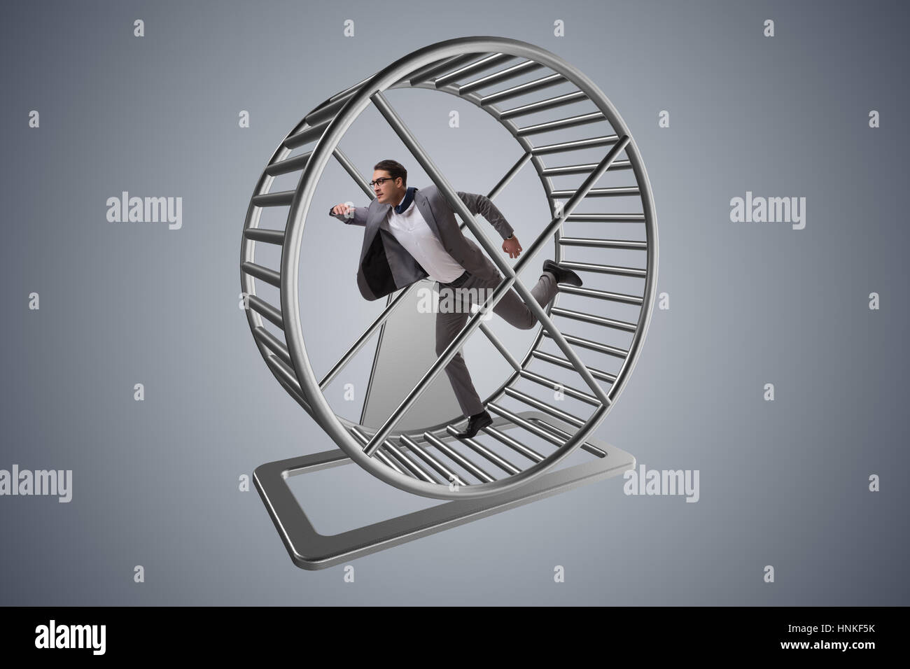 Businessman running on hamster wheel Stock Photo - Alamy