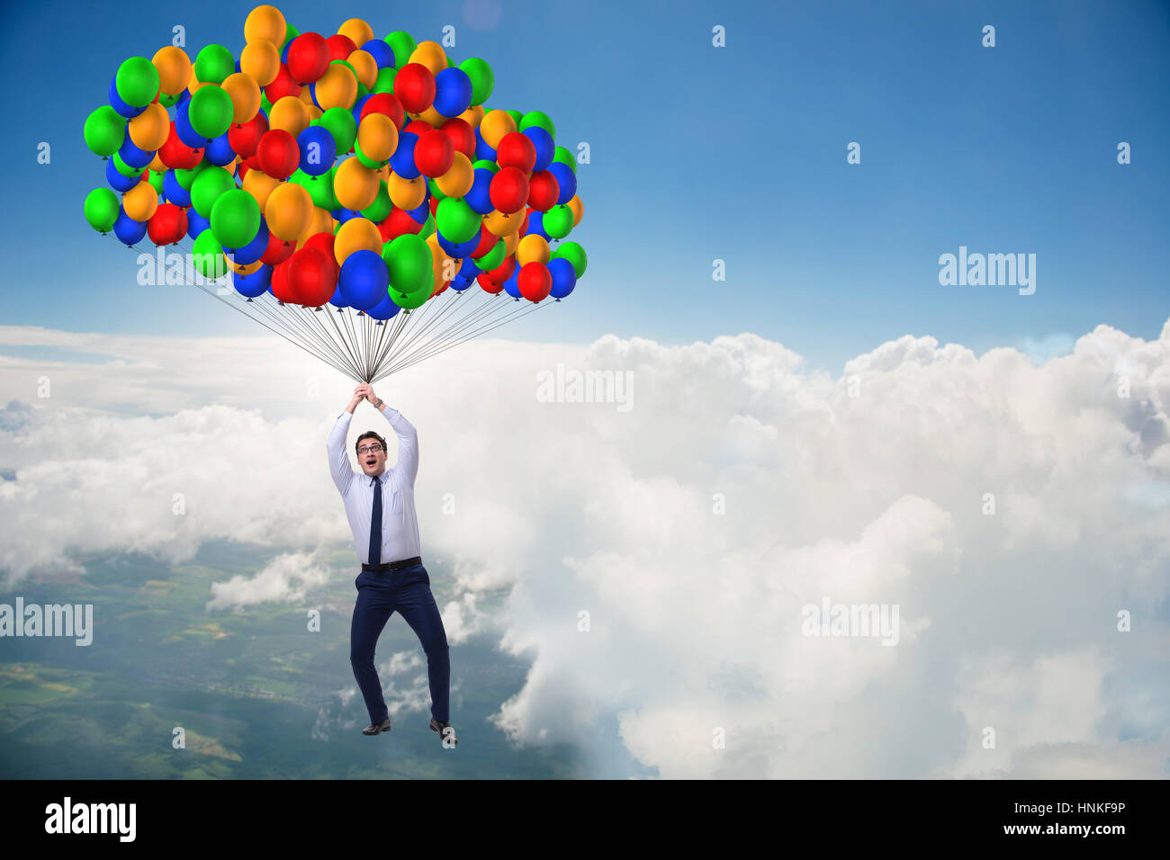 Businessman flying on balloons in challenge concept Stock Photo - Alamy