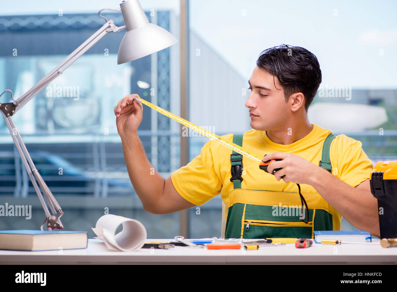 Construction worker sitting at the desk Stock Photo - Alamy