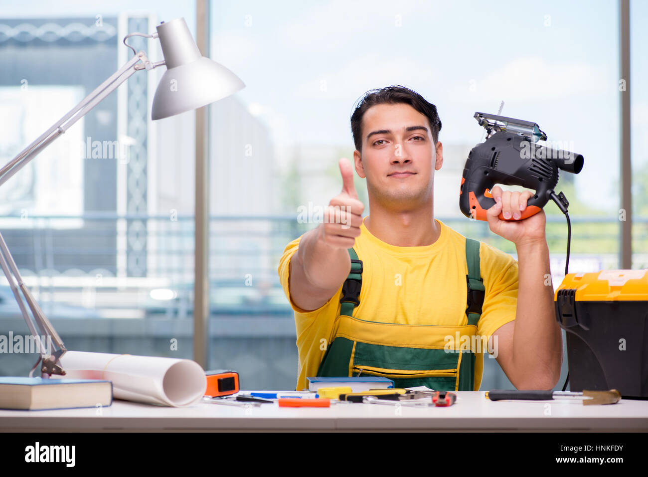 Construction worker sitting at the desk Stock Photo - Alamy