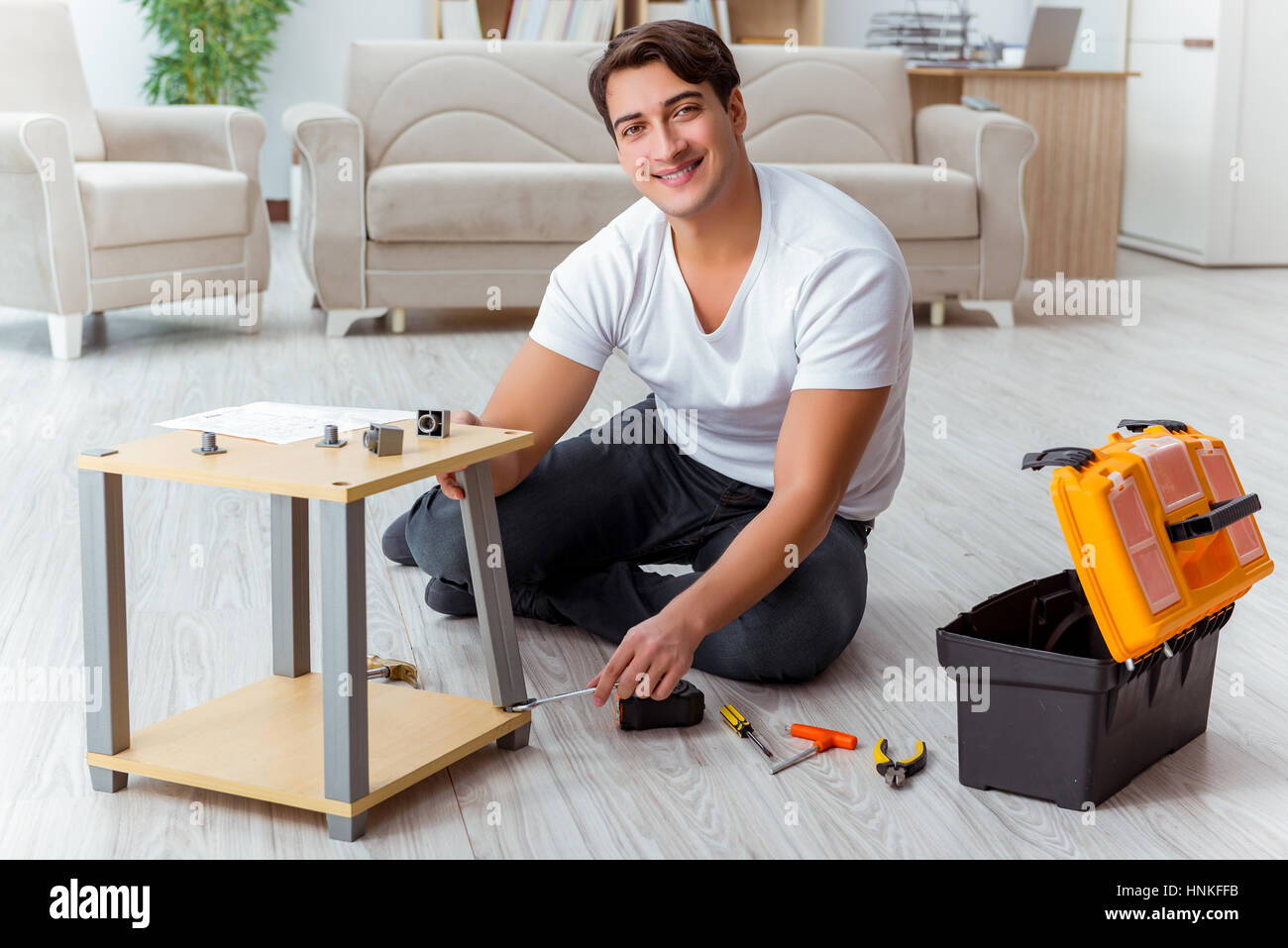 Man assembling furniture at home Stock Photo - Alamy